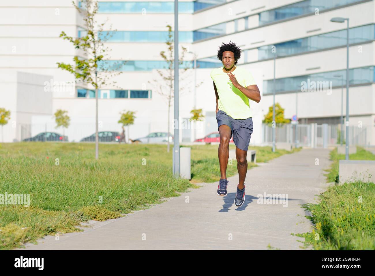 Black athletic man running in an urban park Stock Photo - Alamy