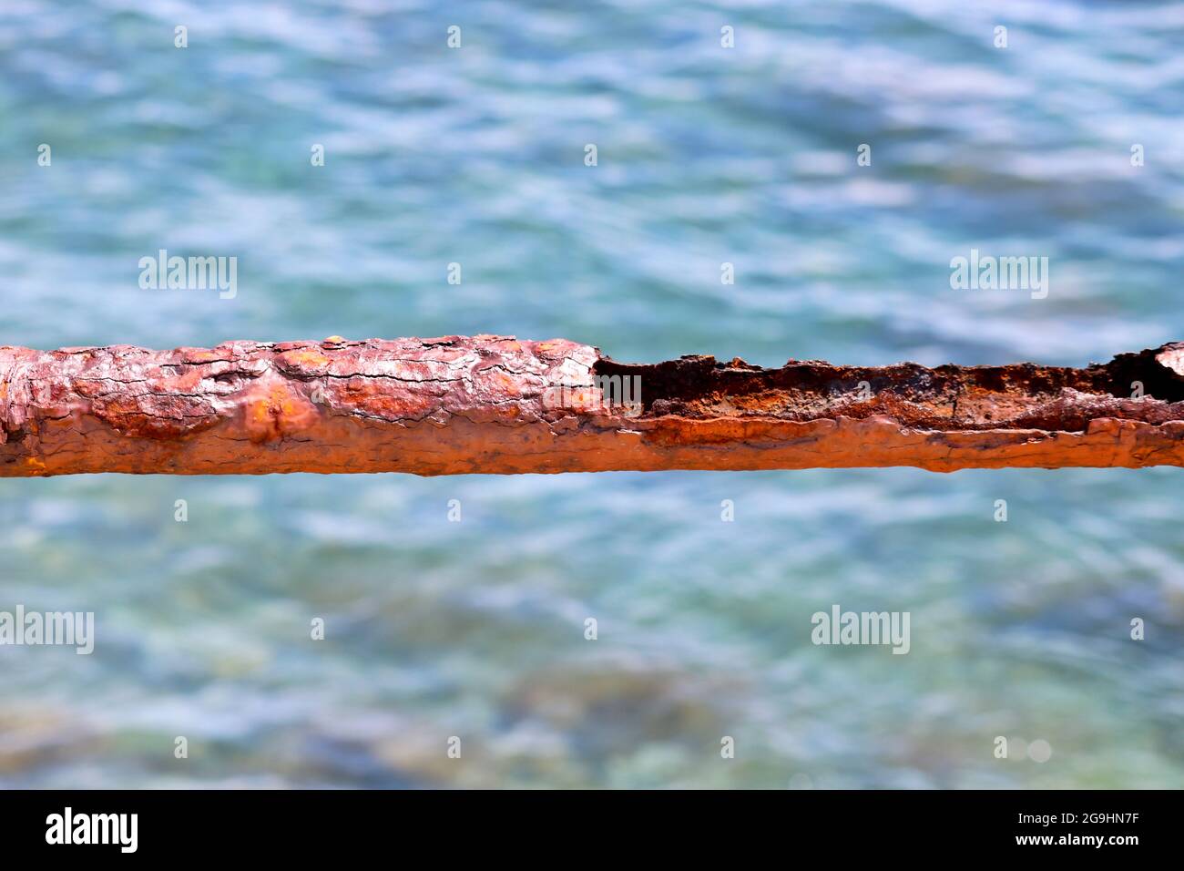 Remains of a rusted handrails on an abandoned waterfront on a blurred ...