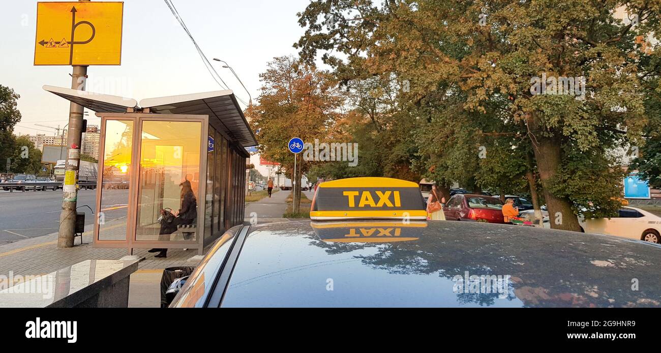 Light box checker taxi bright yellow on the roof of the car on a ...