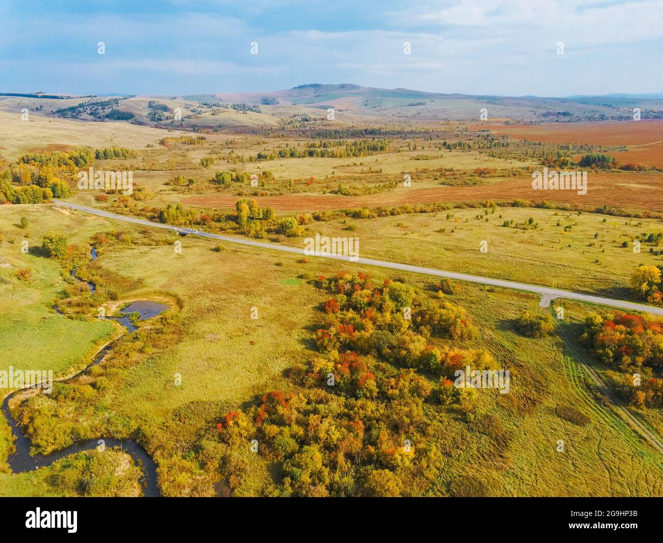 Aerial view of the autumn landscape with hills and bright yellow colors ...
