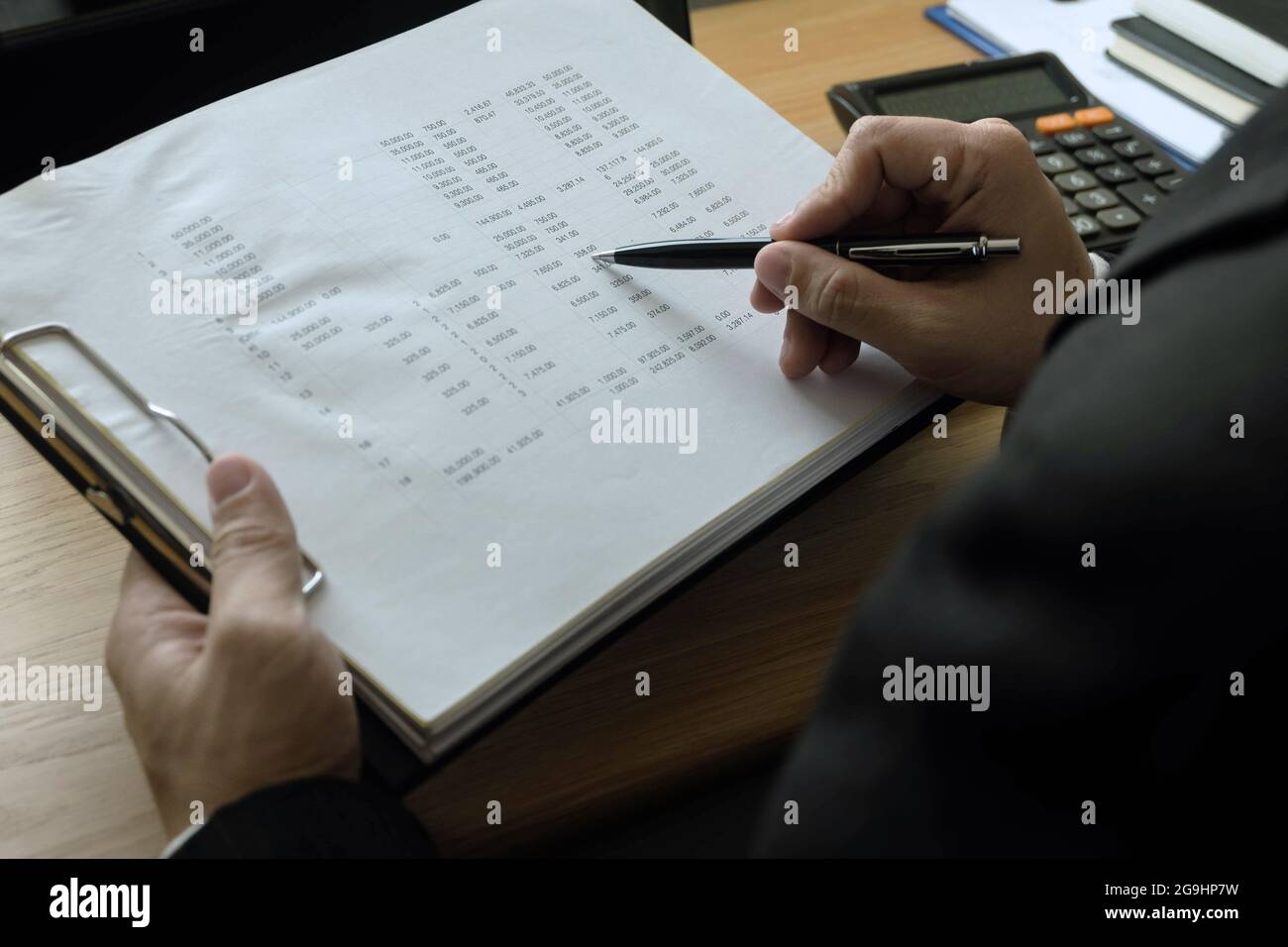 Businessmen are pointing numbers, graph, chart in business results ...