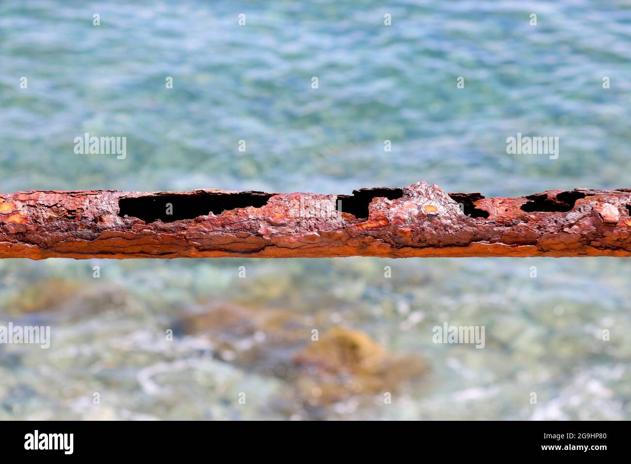 Remains of a rusted handrails on an abandoned waterfront on a blurred ...