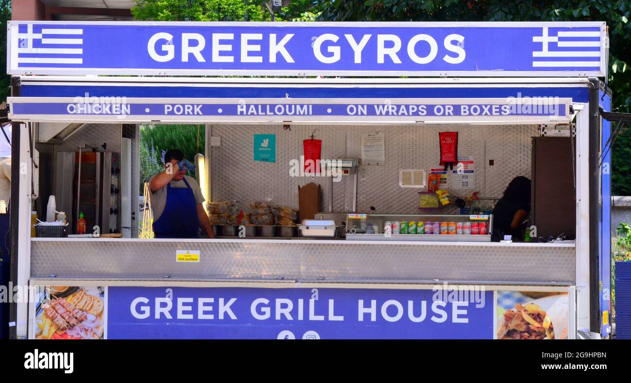 People staff a mobile stall selling Greek food in central Manchester ...