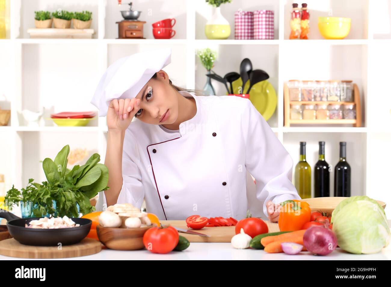 Young woman chef cooking in kitchen Stock Photo - Alamy