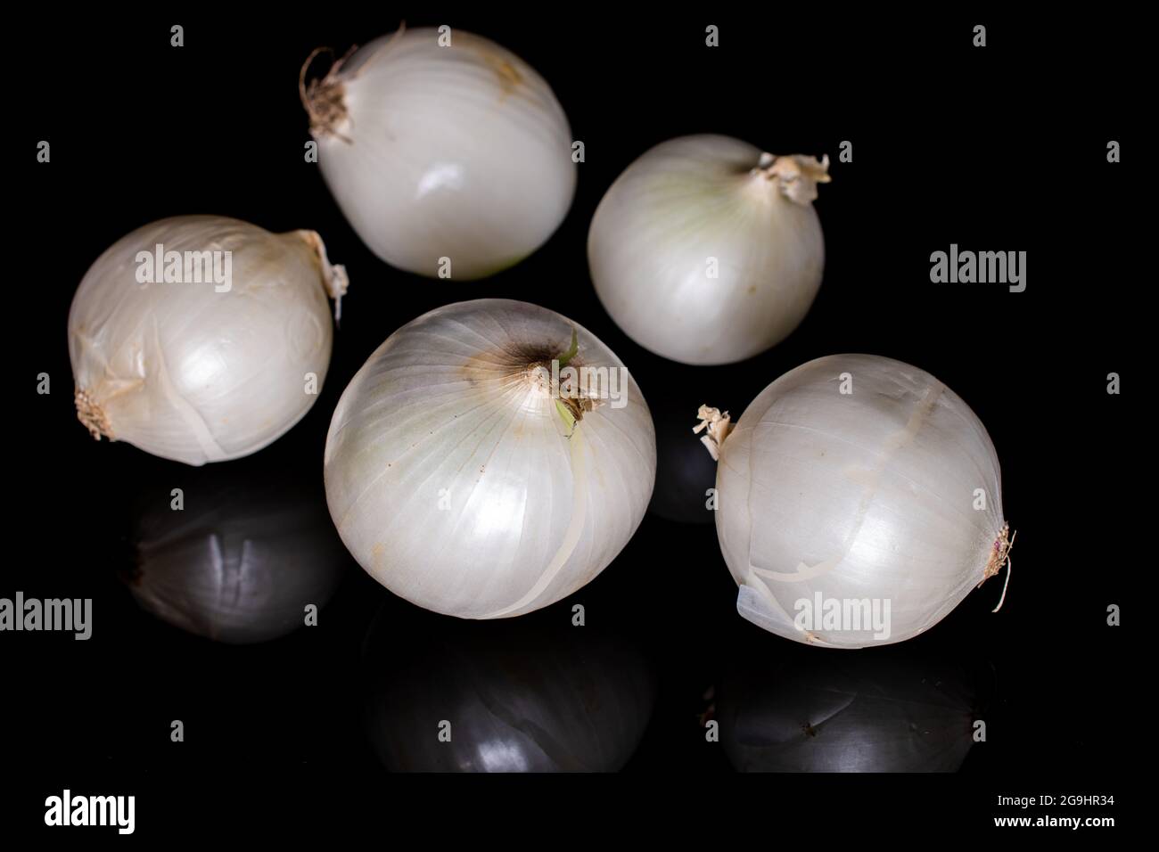 Five organic white onions, close-up, isolated on black Stock Photo - Alamy
