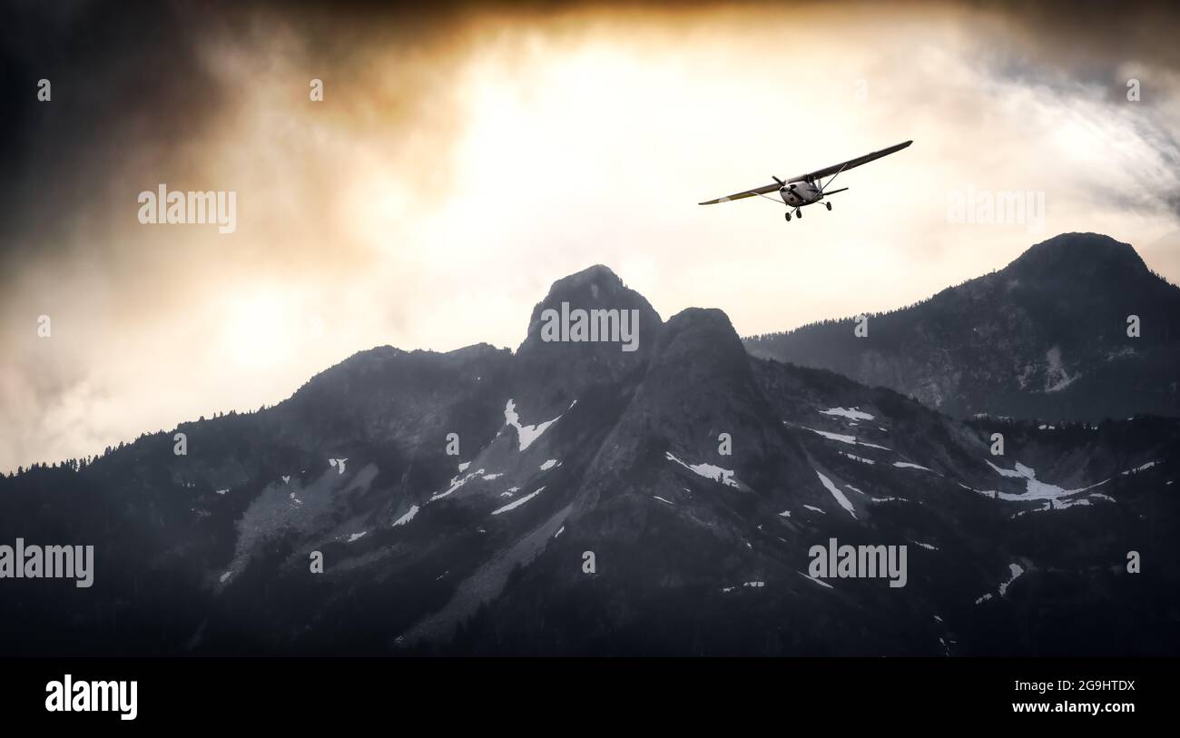 Airplane flying near the Beautiful Canadian Mountain Nature Landscape ...