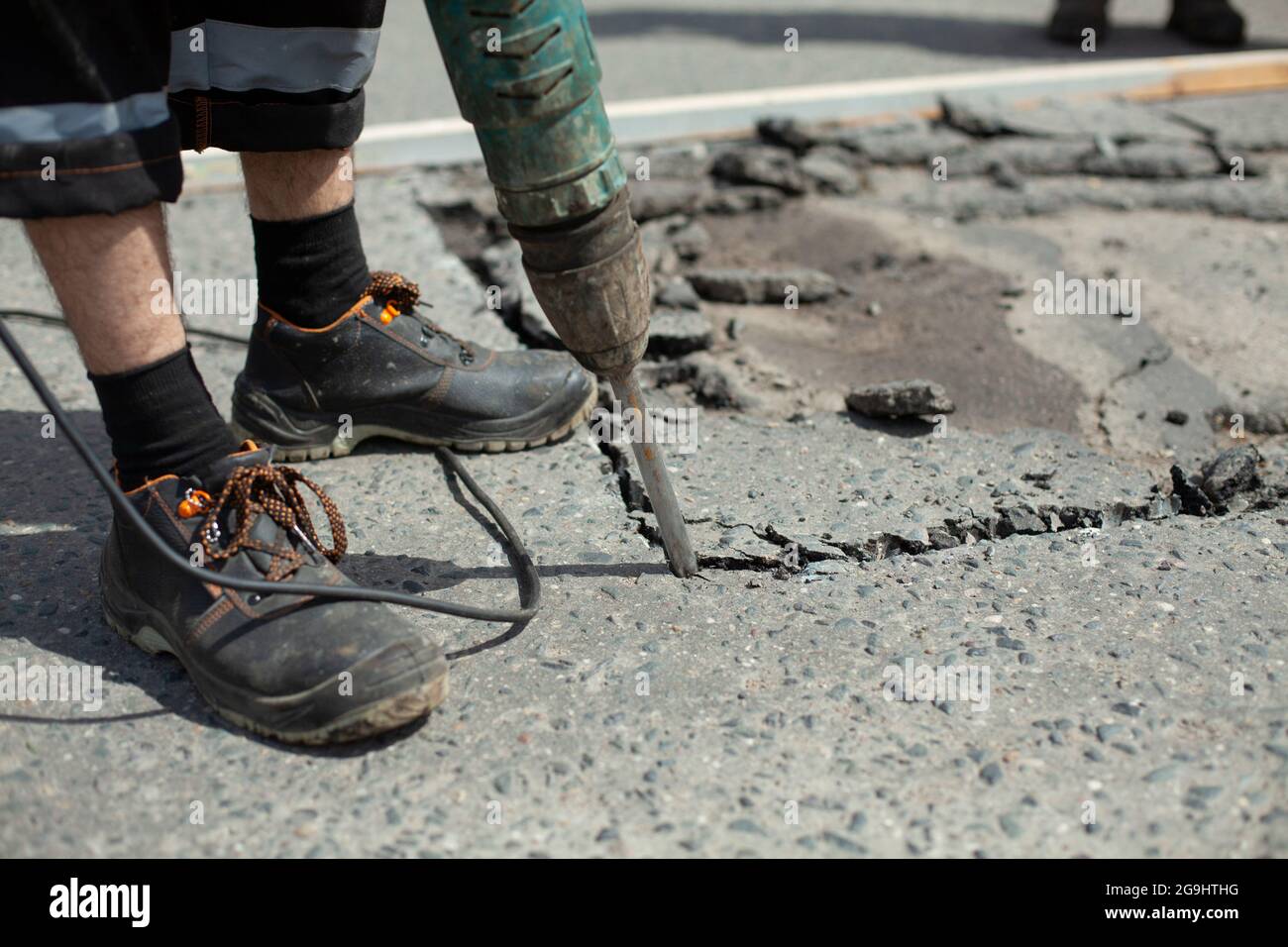 He removes the asphalt with a jackhammer. Removing the asphalt layer ...