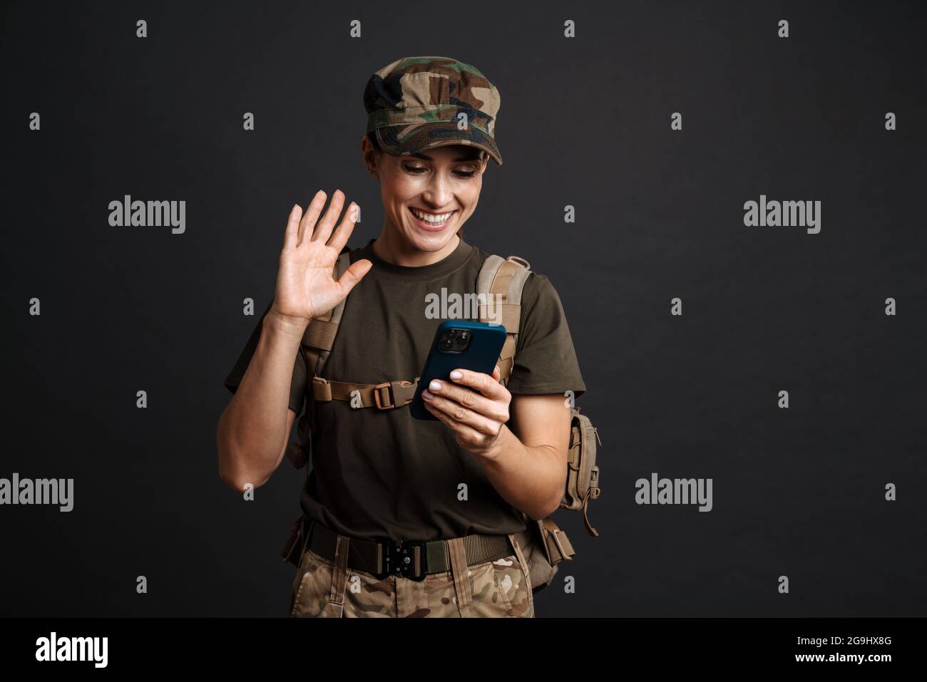 Happy young military woman on a video call with her family through ...