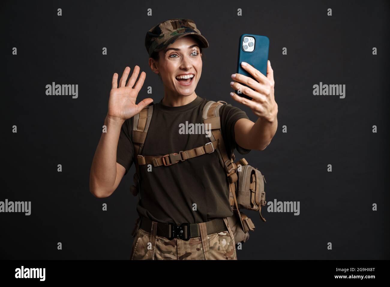 Happy young military woman on a video call with her family through ...