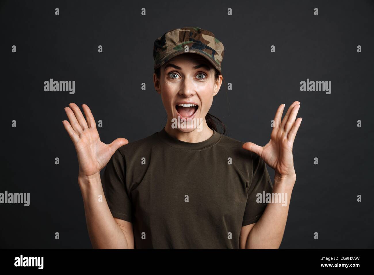 Excited beautiful soldier woman expressing surprise on camera isolated ...