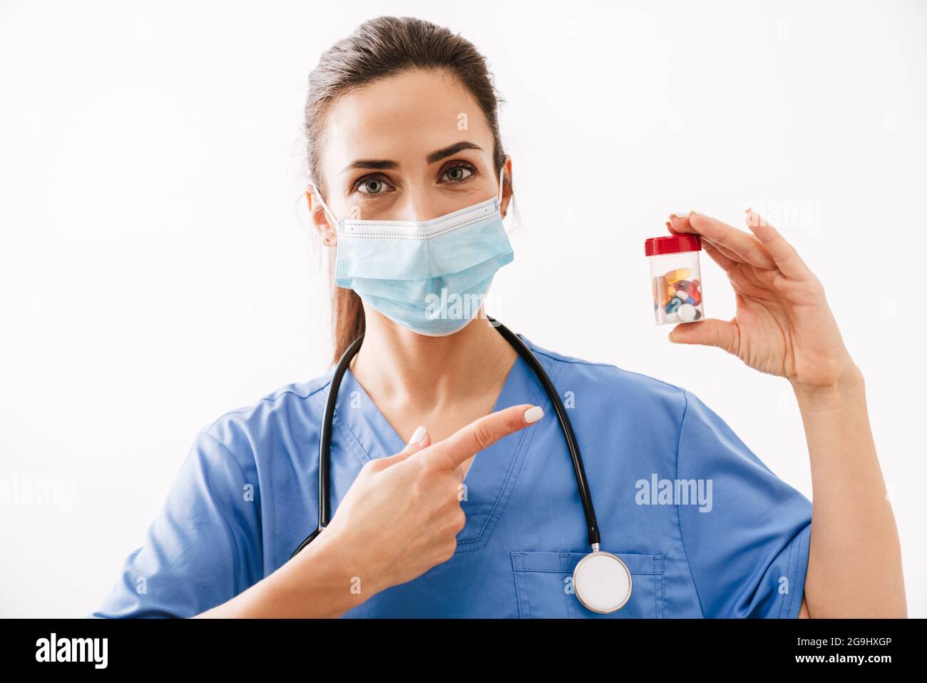 Confident young woman doctir showing bottle with pills isolated over ...