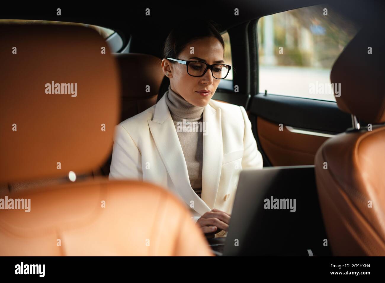 Image of an amazing concentrated business woman sitting in a car and ...