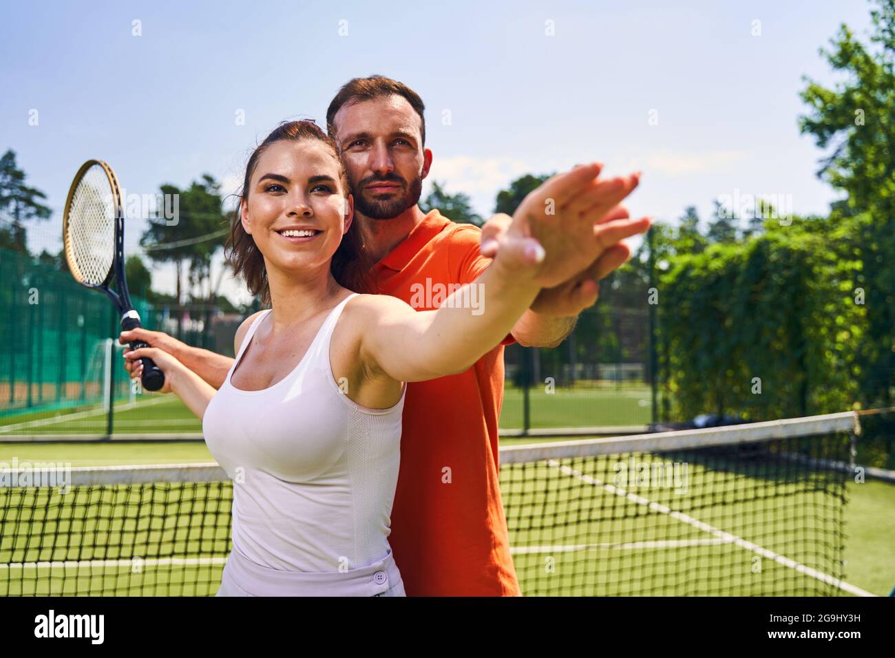 Female beginner tennis player mastering the correct hand motion Stock ...