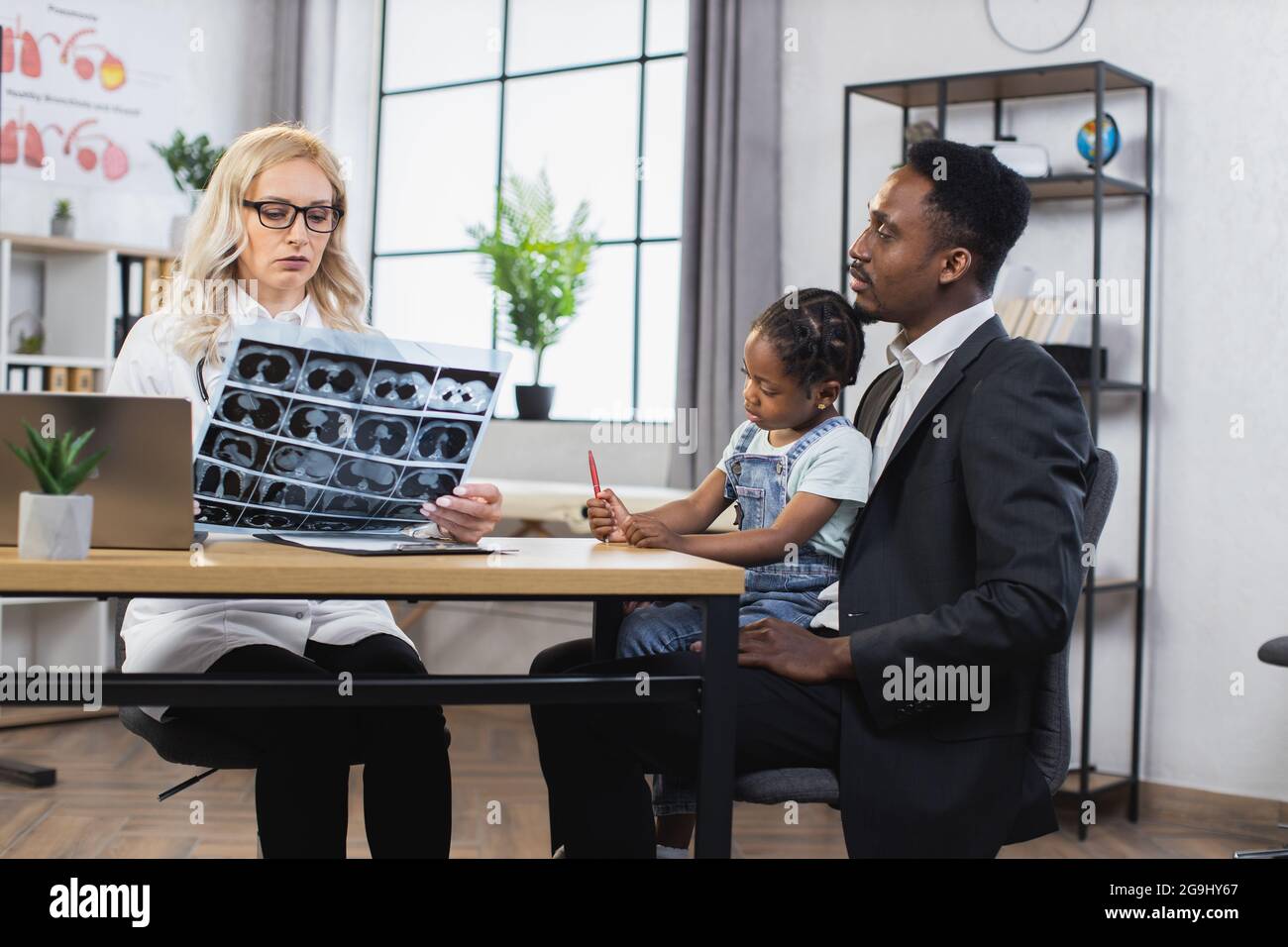 Handsome young african american father with his adorable little ...