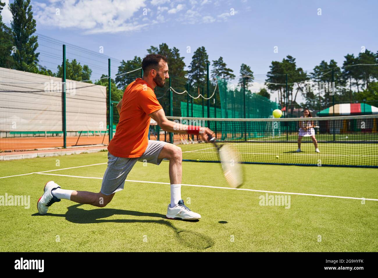 Focused athlete playing a singles match with his tennis partner Stock ...