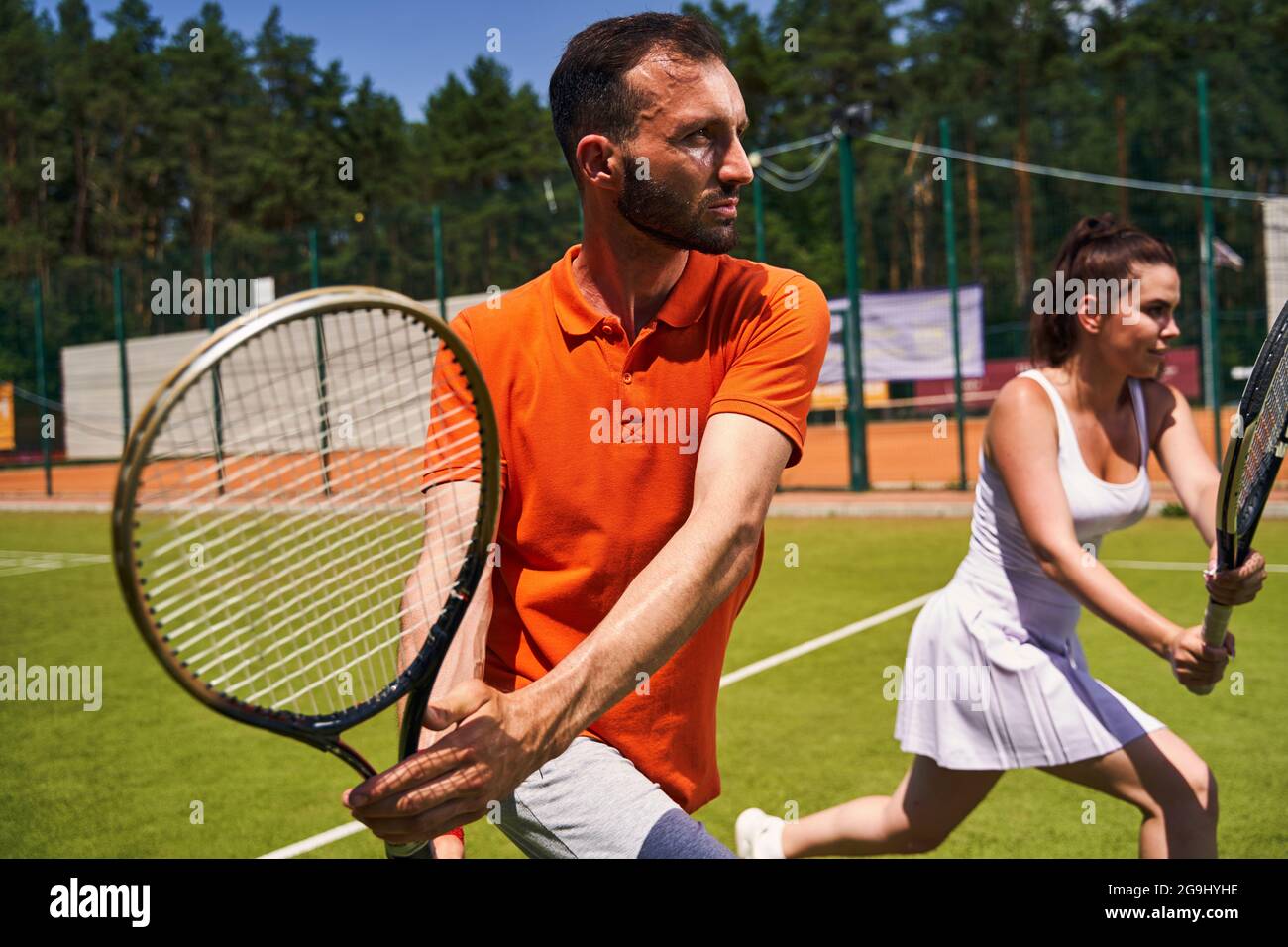 Two tennis players waiting to receive a serve Stock Photo - Alamy