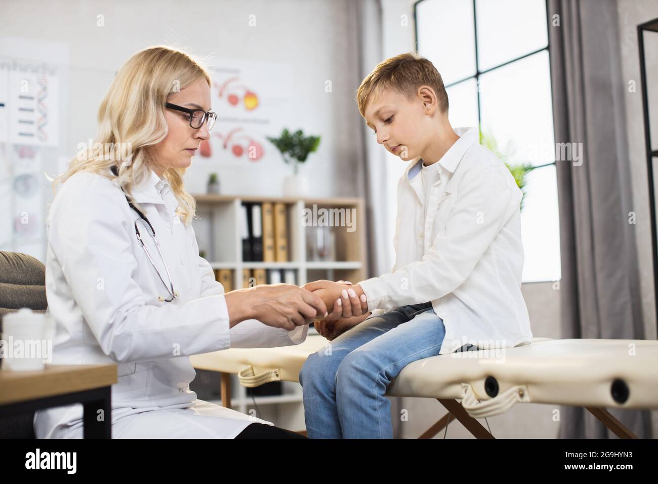 Teenage boy having medical consultation with competent doctor at modern ...