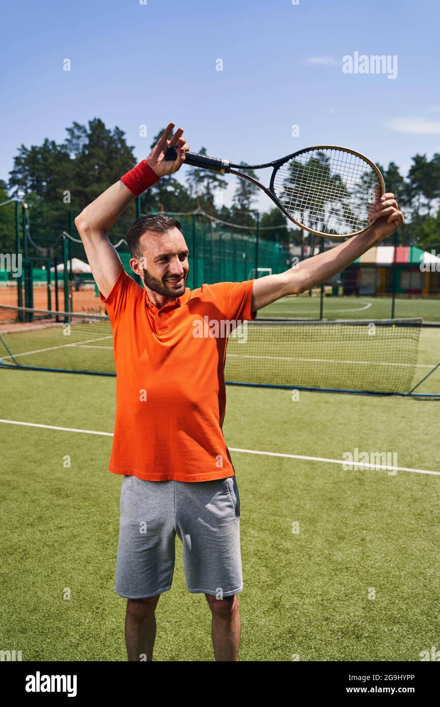 Professional tennis player doing a warm-up exercise before the match ...