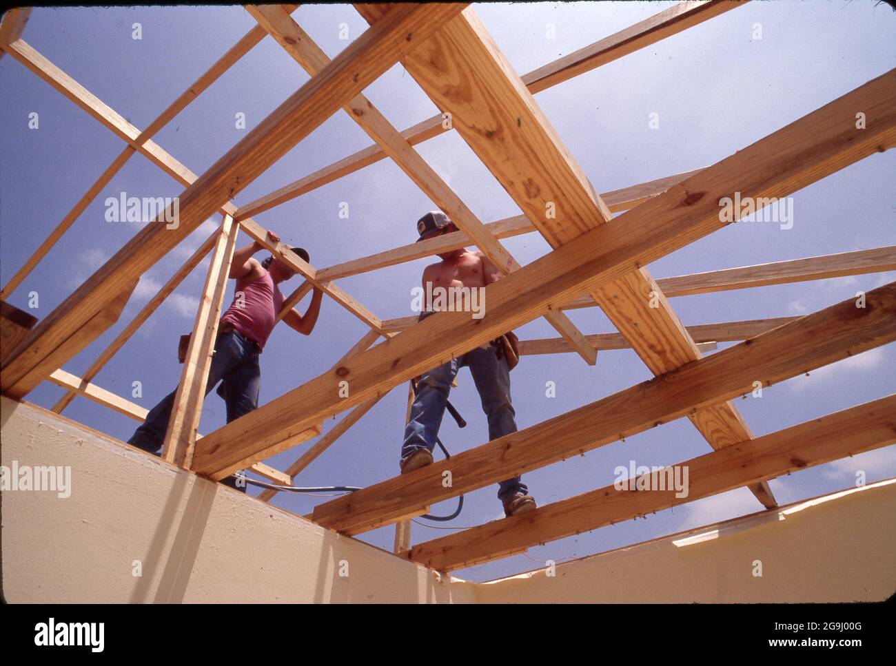 Jarrell Texas USA, 1997: Workers repair the roof of a house damaged by ...