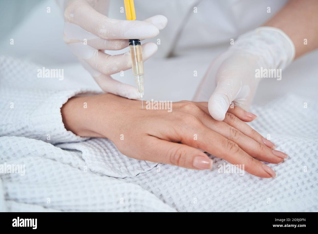 Kind female person doing professional skincare procedure Stock Photo ...