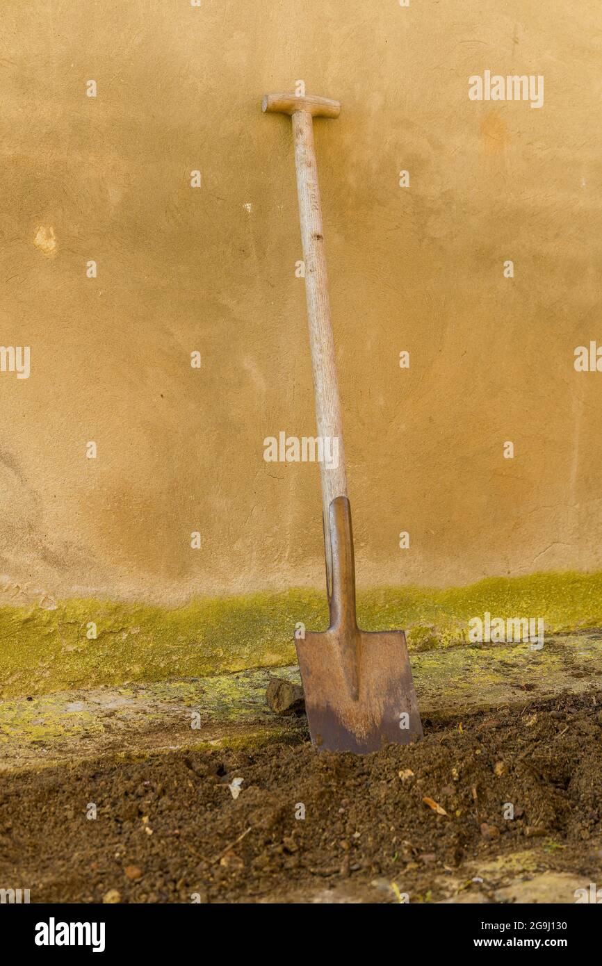 Vertical shot of a shovel on the land Stock Photo - Alamy