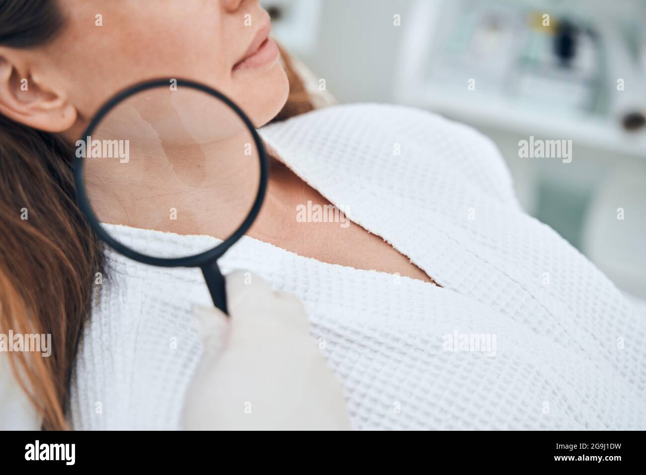 Professional cosmetologist doing examination of female skin Stock Photo ...