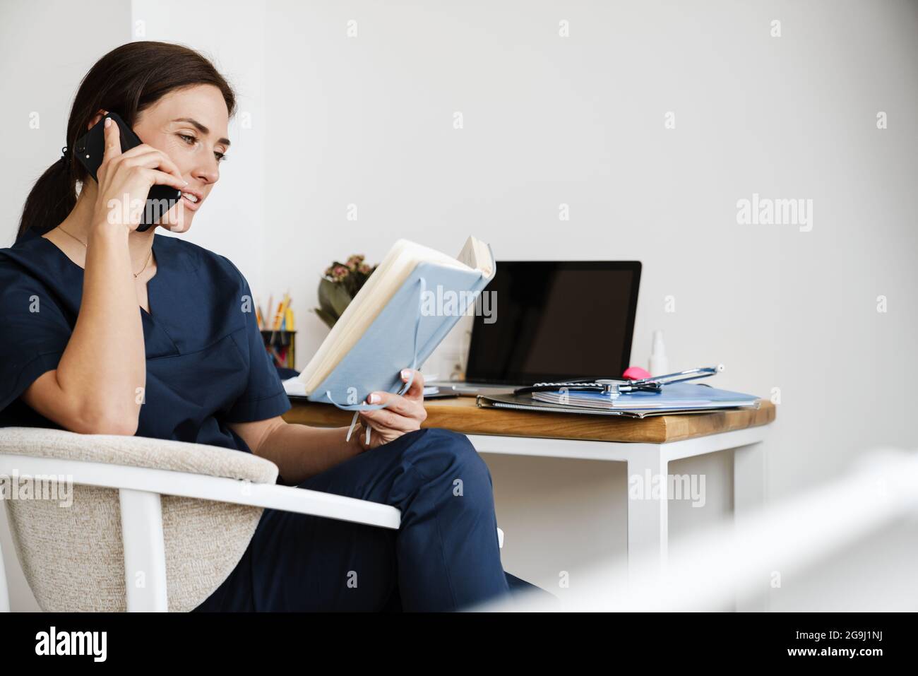 Woman sitting sideways in chair hi-res stock photography and images - Alamy