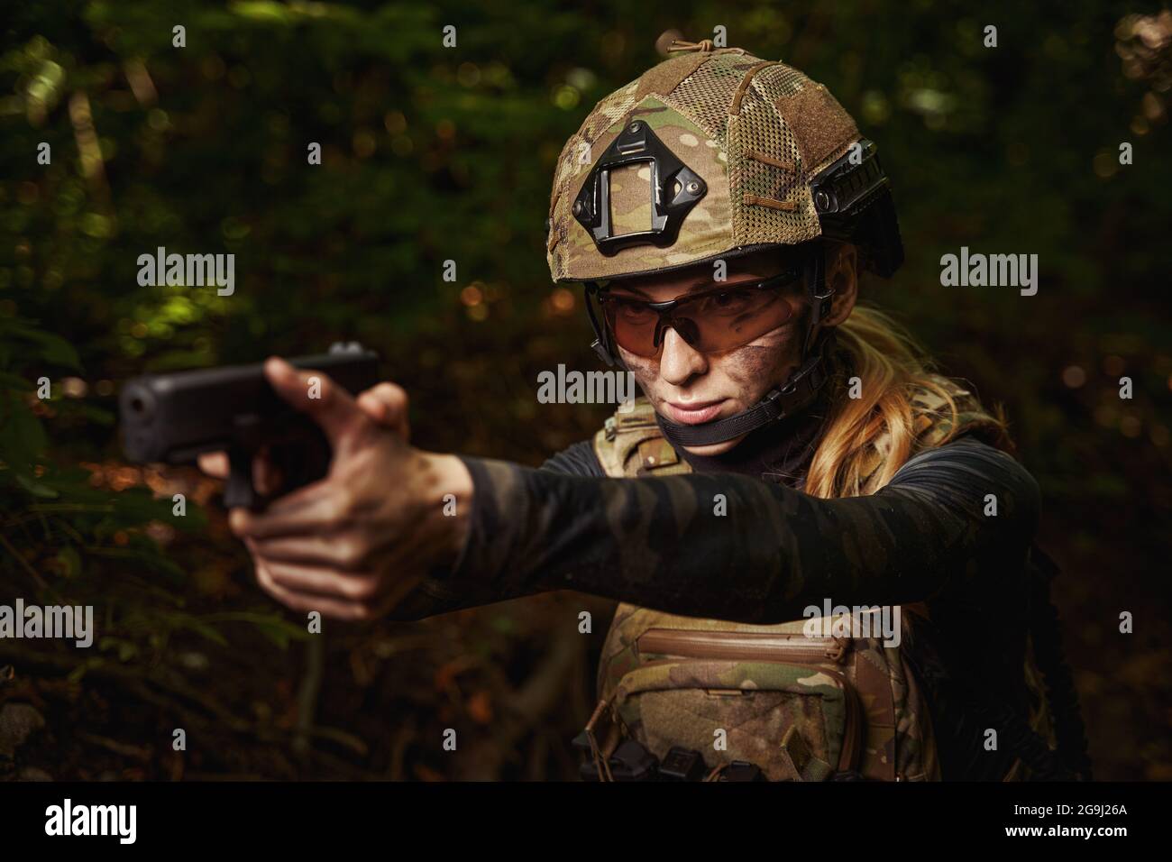 Female person in helmet aiming at target Stock Photo - Alamy