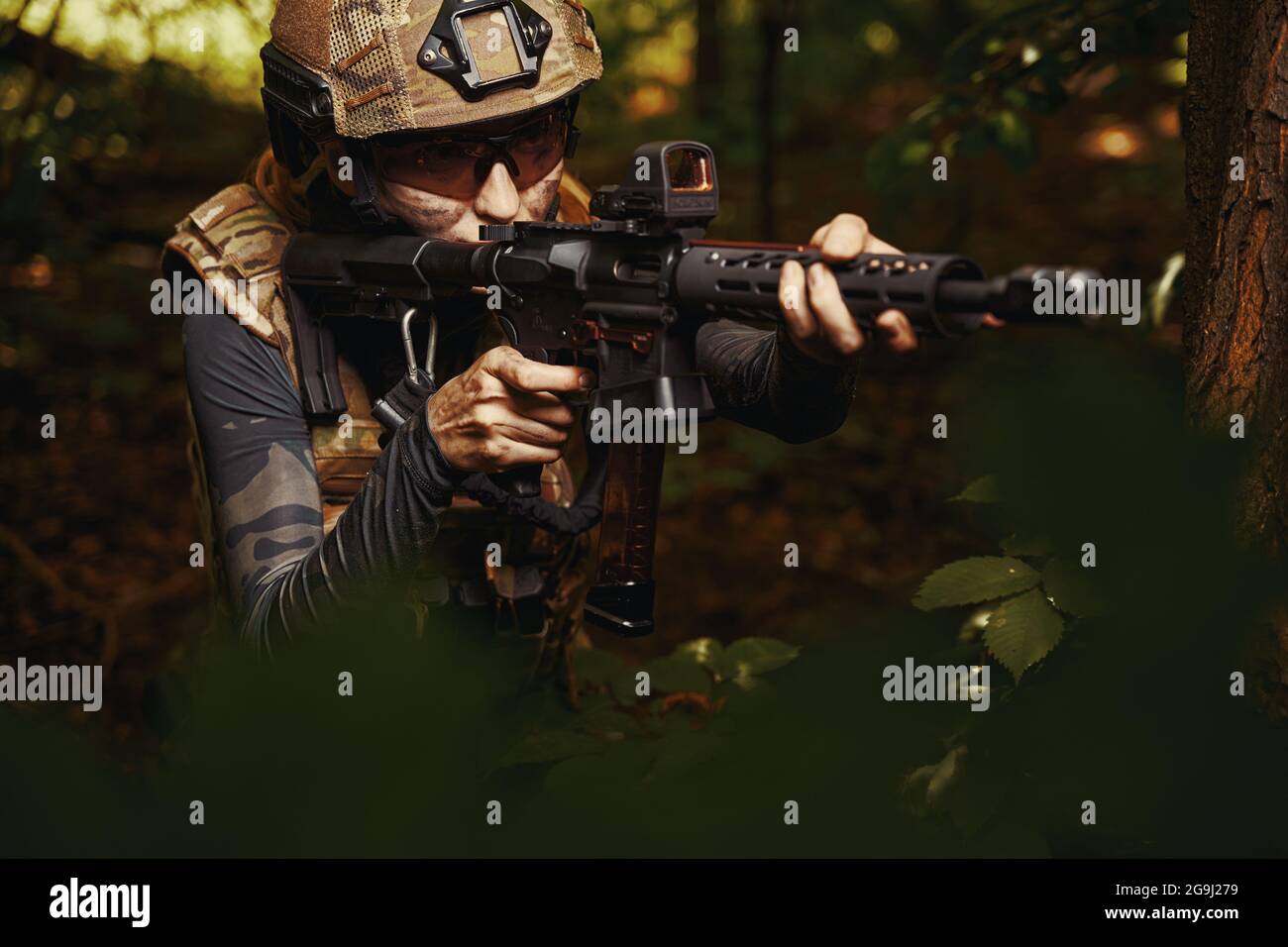 Female person with gun spending time in forest Stock Photo - Alamy