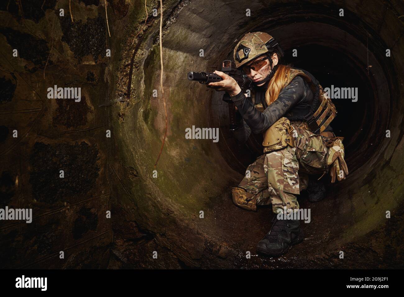 Female person walking through pipe in search of target Stock Photo - Alamy