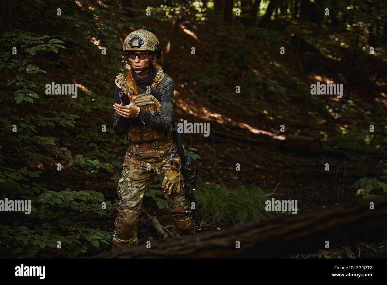 Female person wearing camouflage uniform and helmet Stock Photo - Alamy
