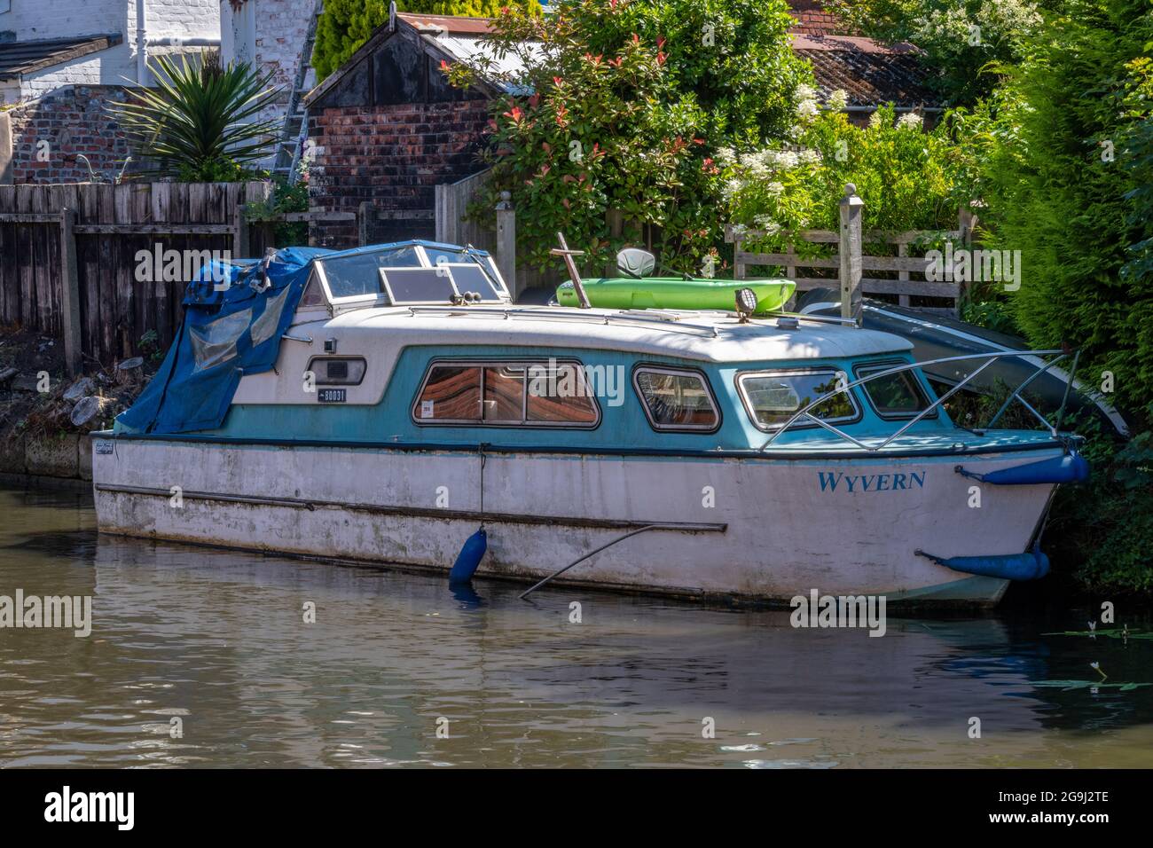 an old canal cruiser boat in a poor state of repair forgotten and ...
