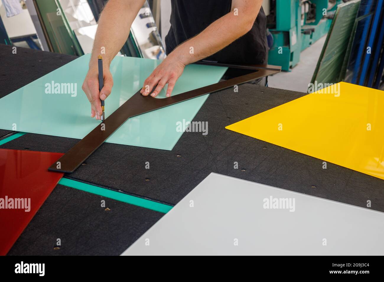 cutting colored glass in the glass workshop Stock Photo - Alamy