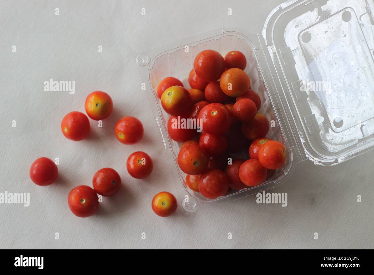 Cherry tomatoes packed in a transparent plastic box. These are a type ...