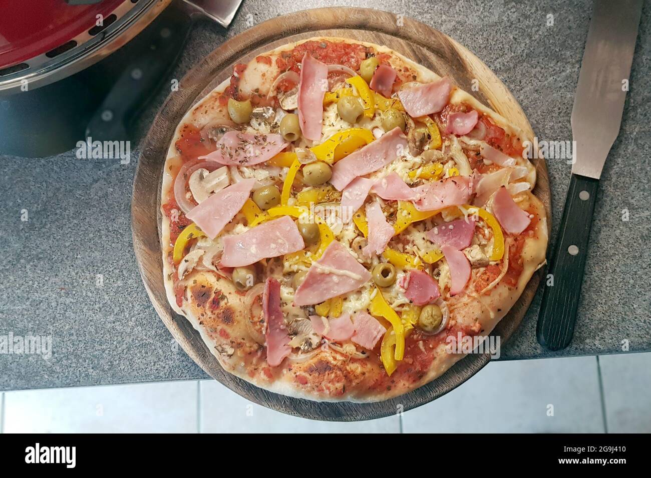 Homemade pizza with ham and yellow peppers Stock Photo - Alamy