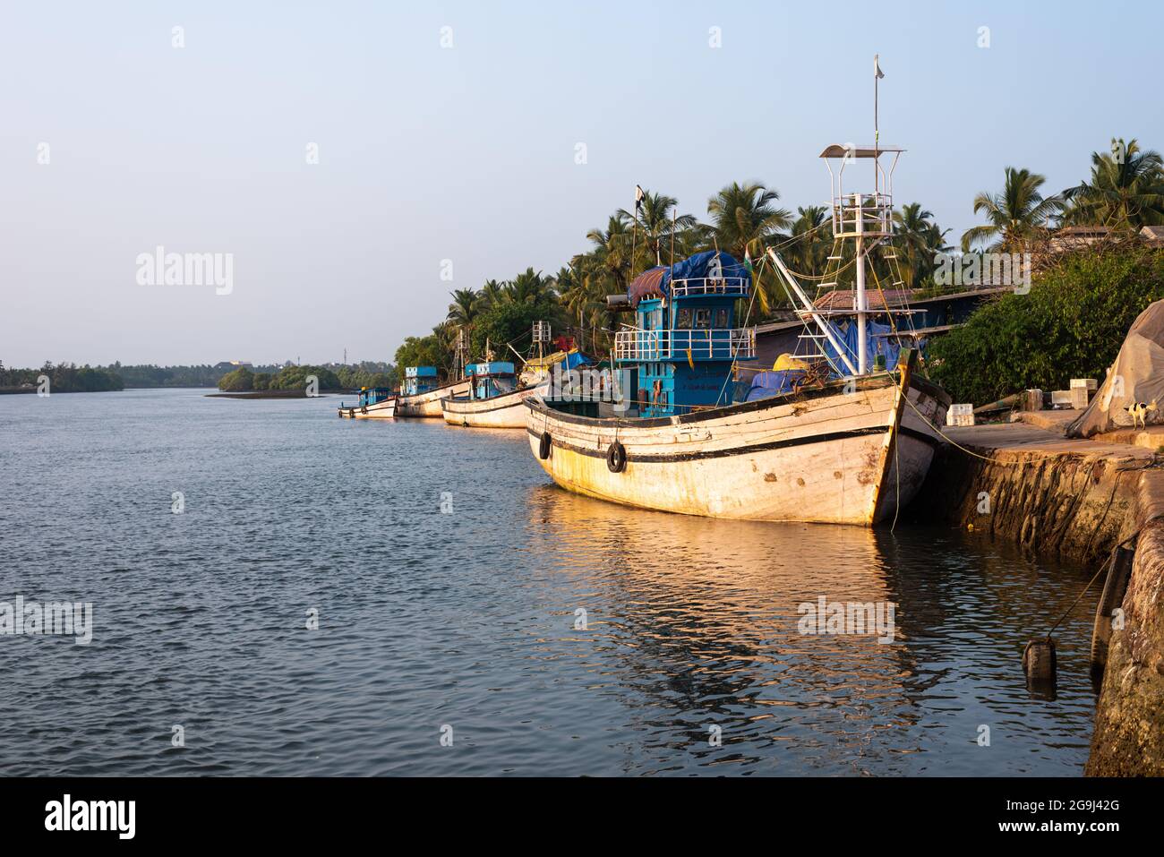 Closeup shot of a small old ship at harbor in a tropical rural area ...