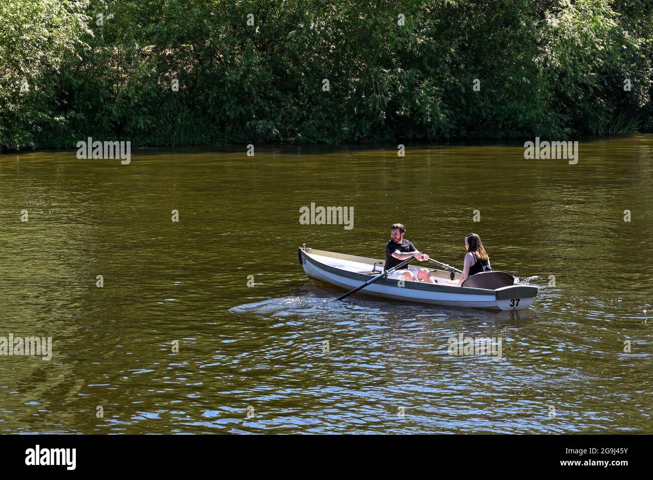 Chester, Cheshire, England - July 2021: Two people in a rowing boat on ...