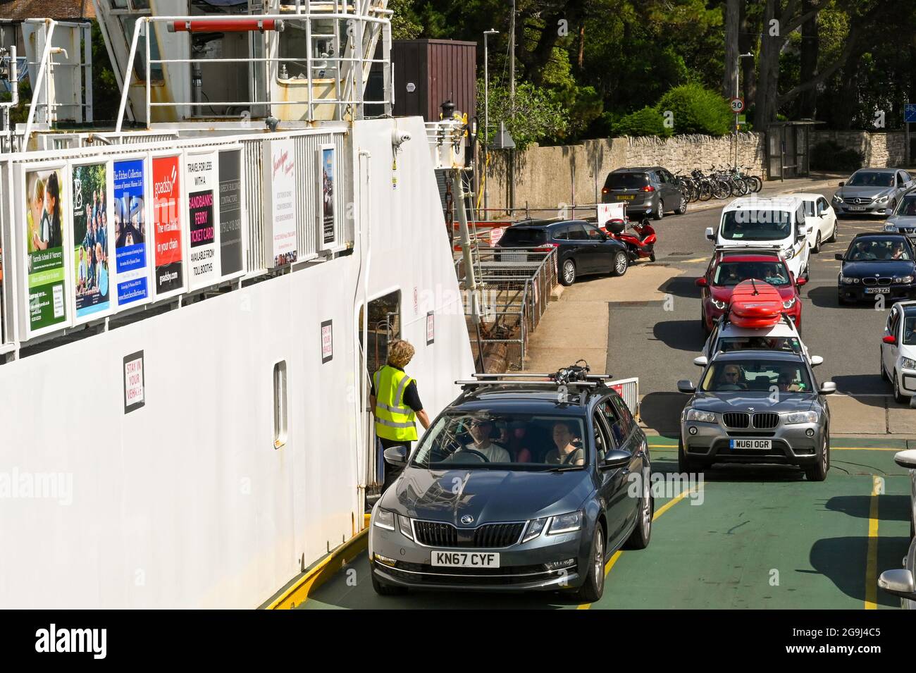 Poole, Dorset, England - June 2021: Cars driving onto the chain ferry ...
