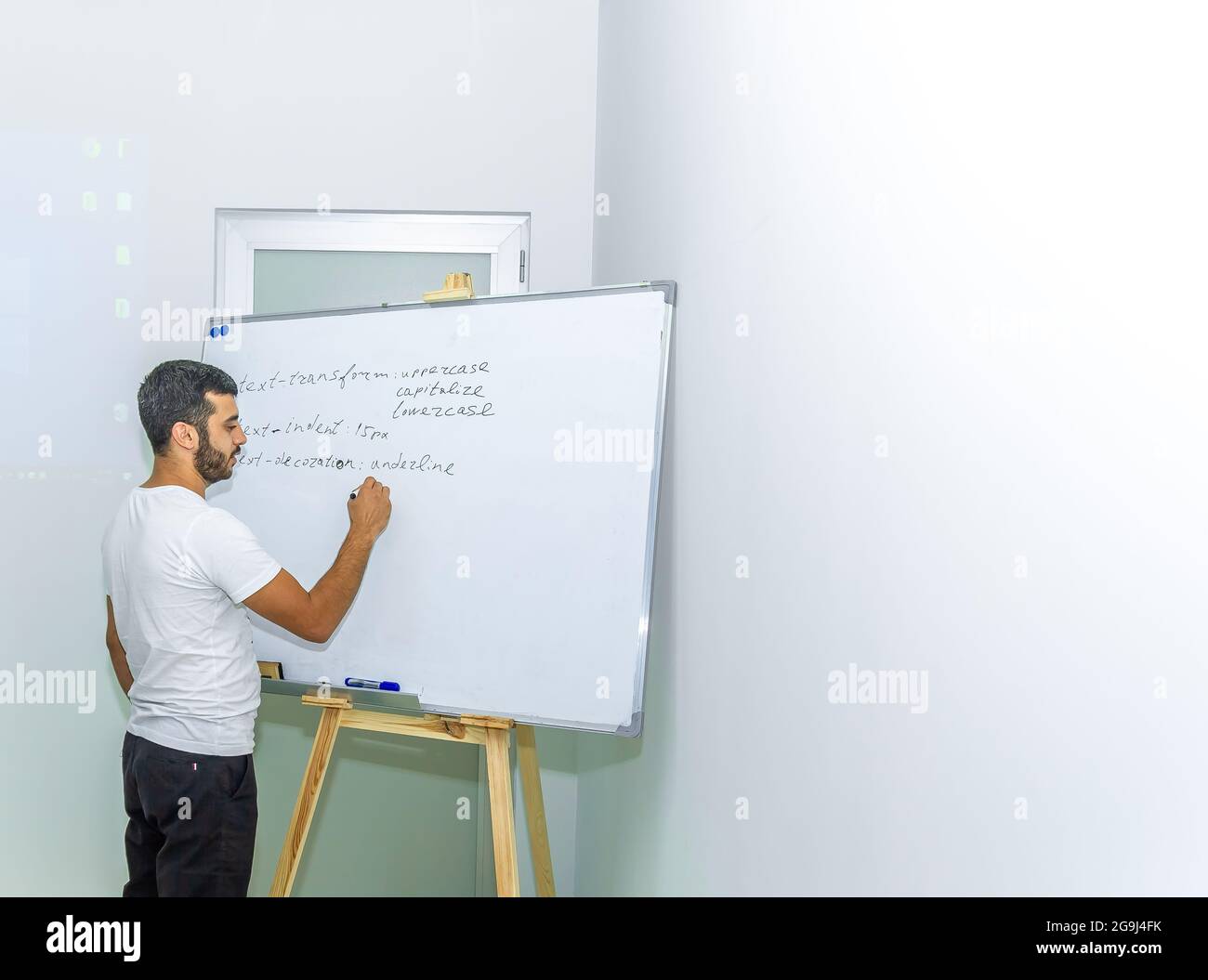 Teacher Writing On Whiteboard