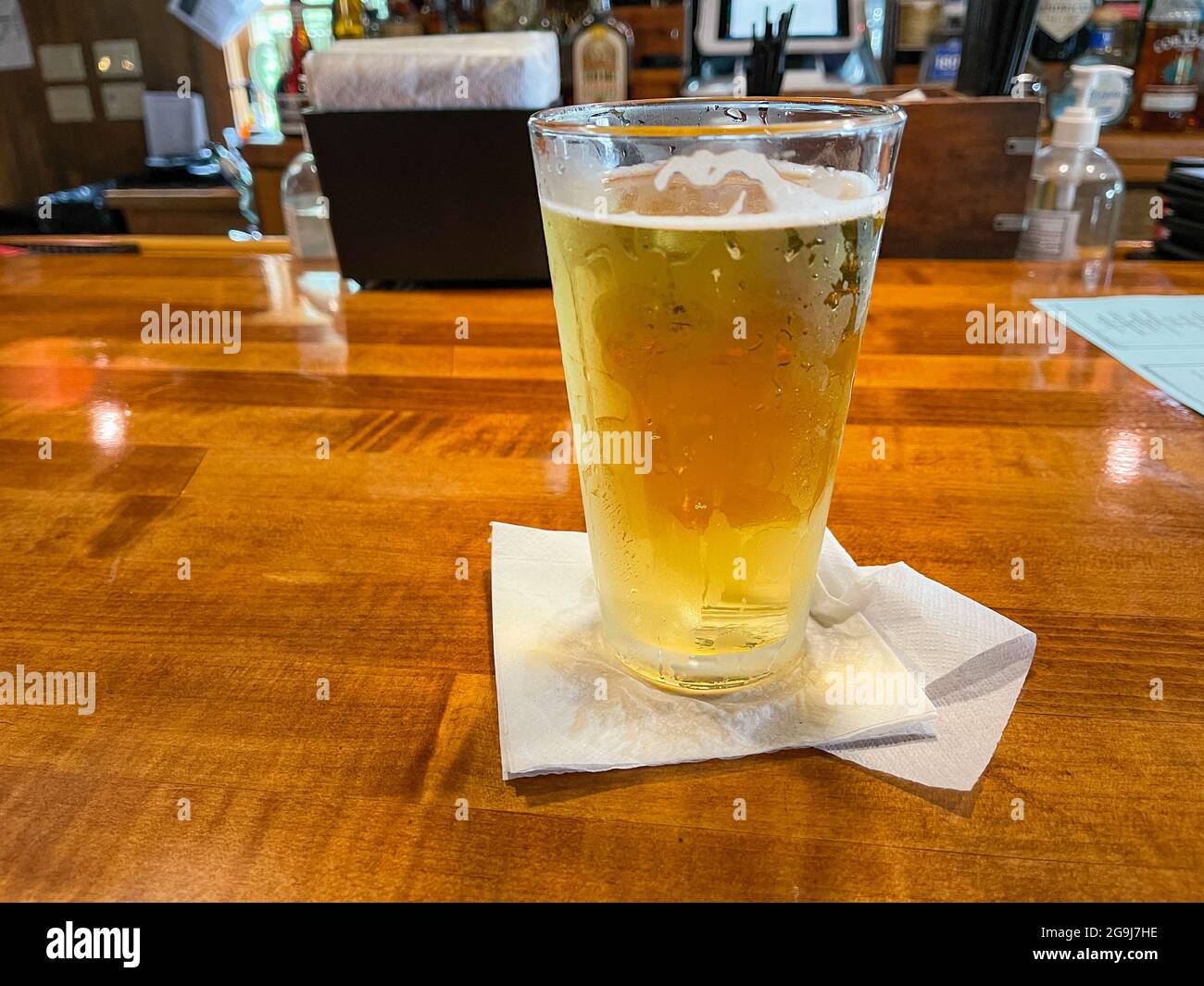 An icy cold draft beer in a glass sitting on a bar in Florida Stock ...