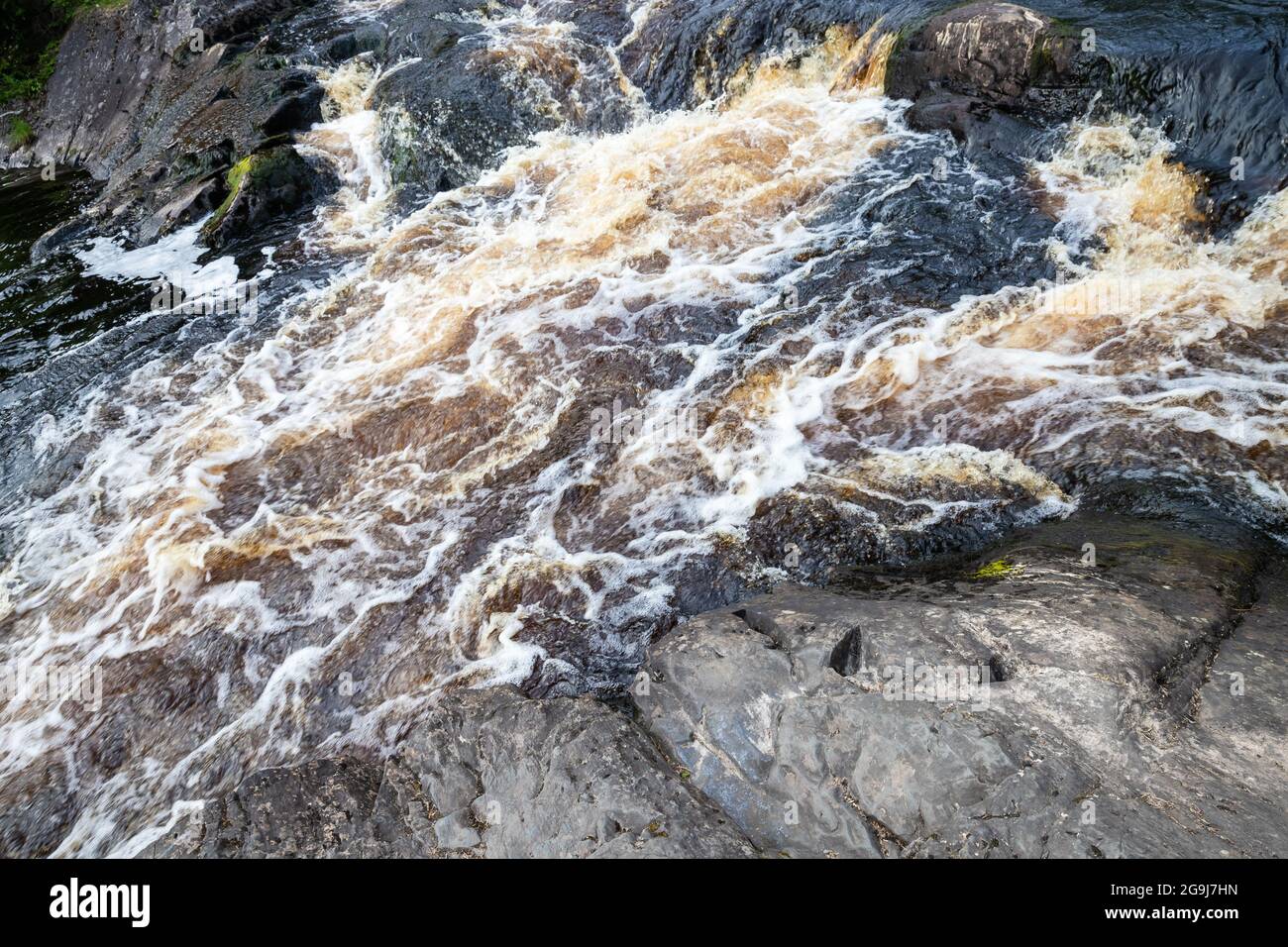 Waterfalls of Ruskeala, fast water with foam goes over gray rocks Stock ...
