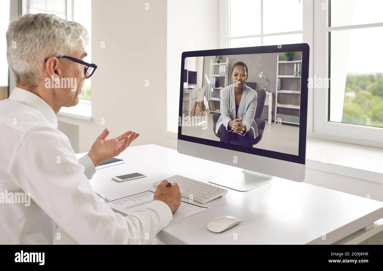 Two business people discussing work in online meeting via video call on ...