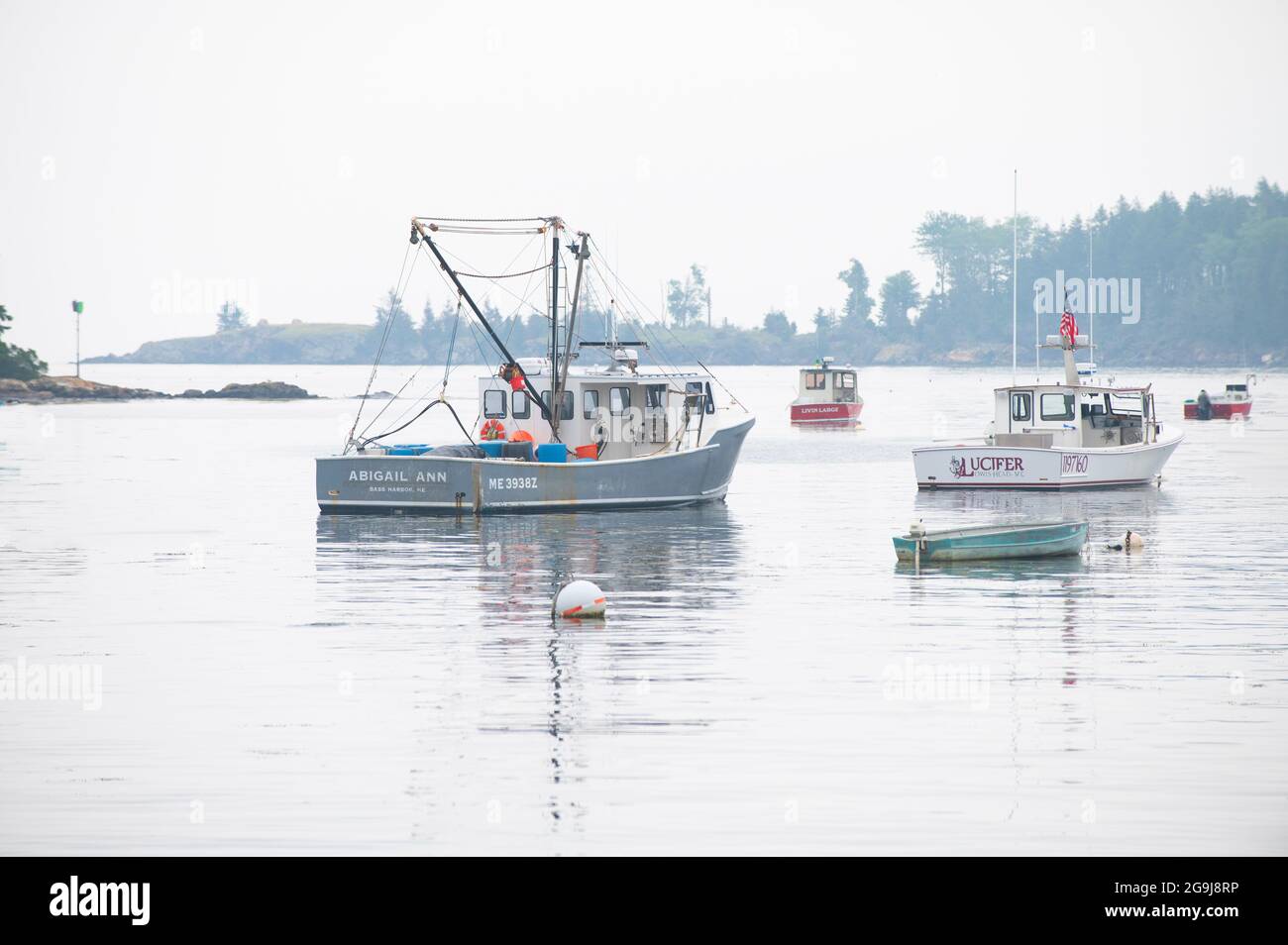 Commercial lobster boats at their moorings on a foggy morning in Owls ...