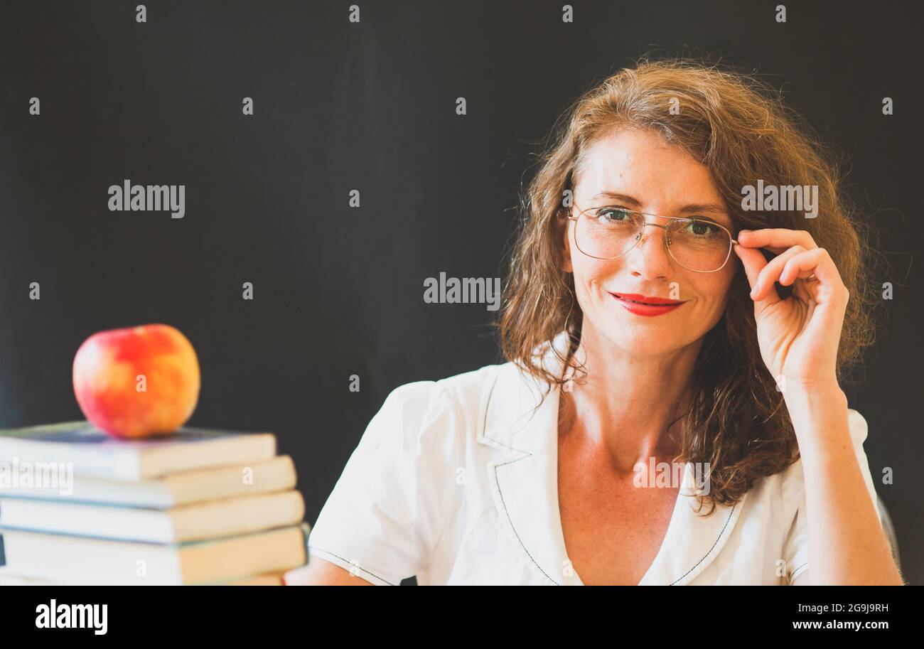 back to school concept teacher in front of chalkboard Stock Photo - Alamy