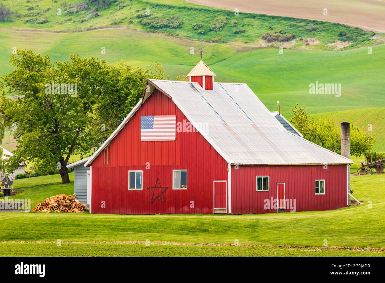 Garfield, Washington, USA. May 24, 2021. A red barn with an American ...
