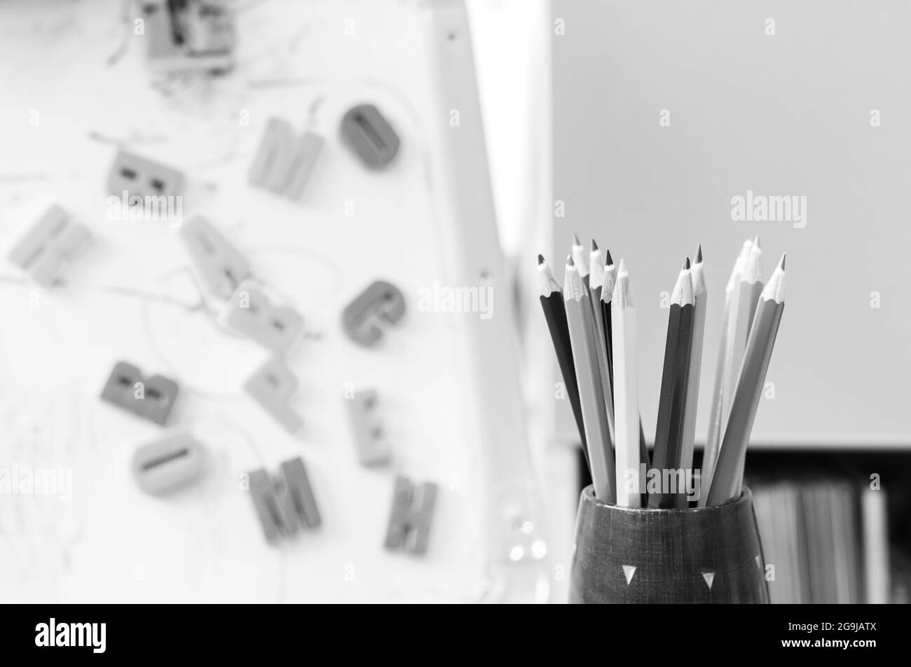 Background made of colored pencils and letters, black & white photo ...