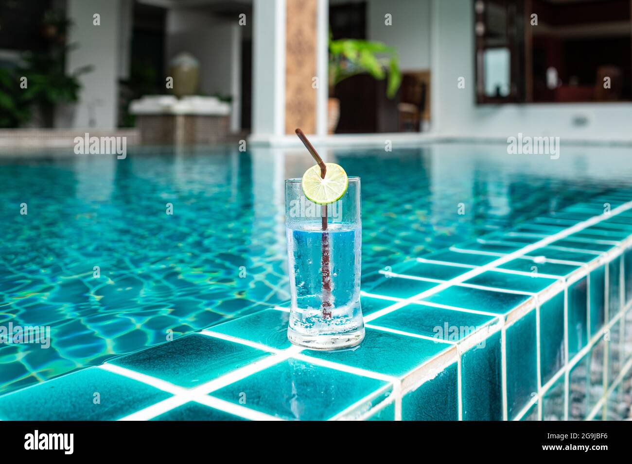A glass of chilled water at the edge of the pool Stock Photo - Alamy