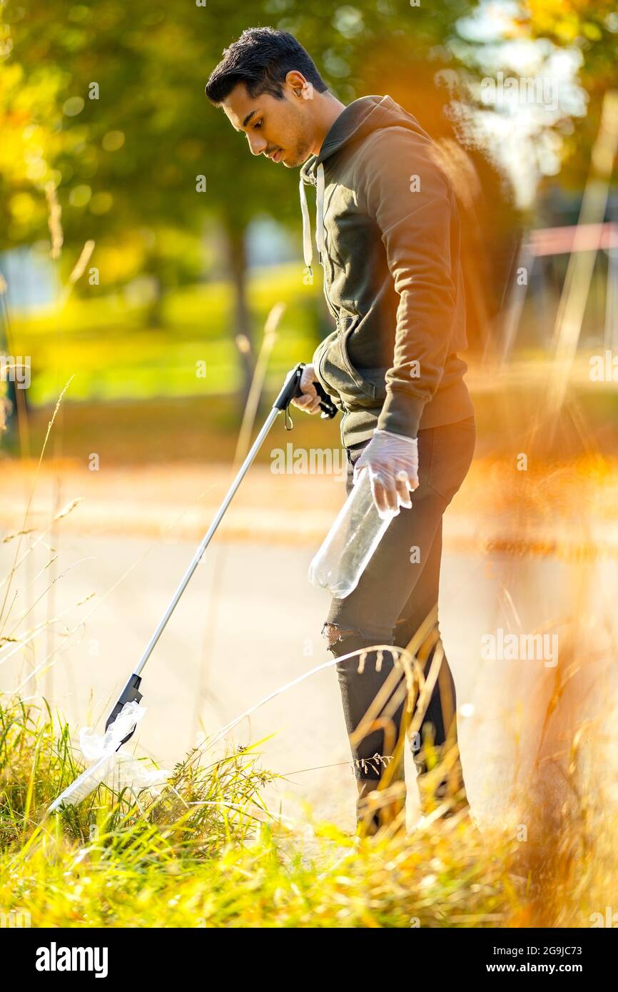 Focused volunteer conserving environment from pollution and plastic ...