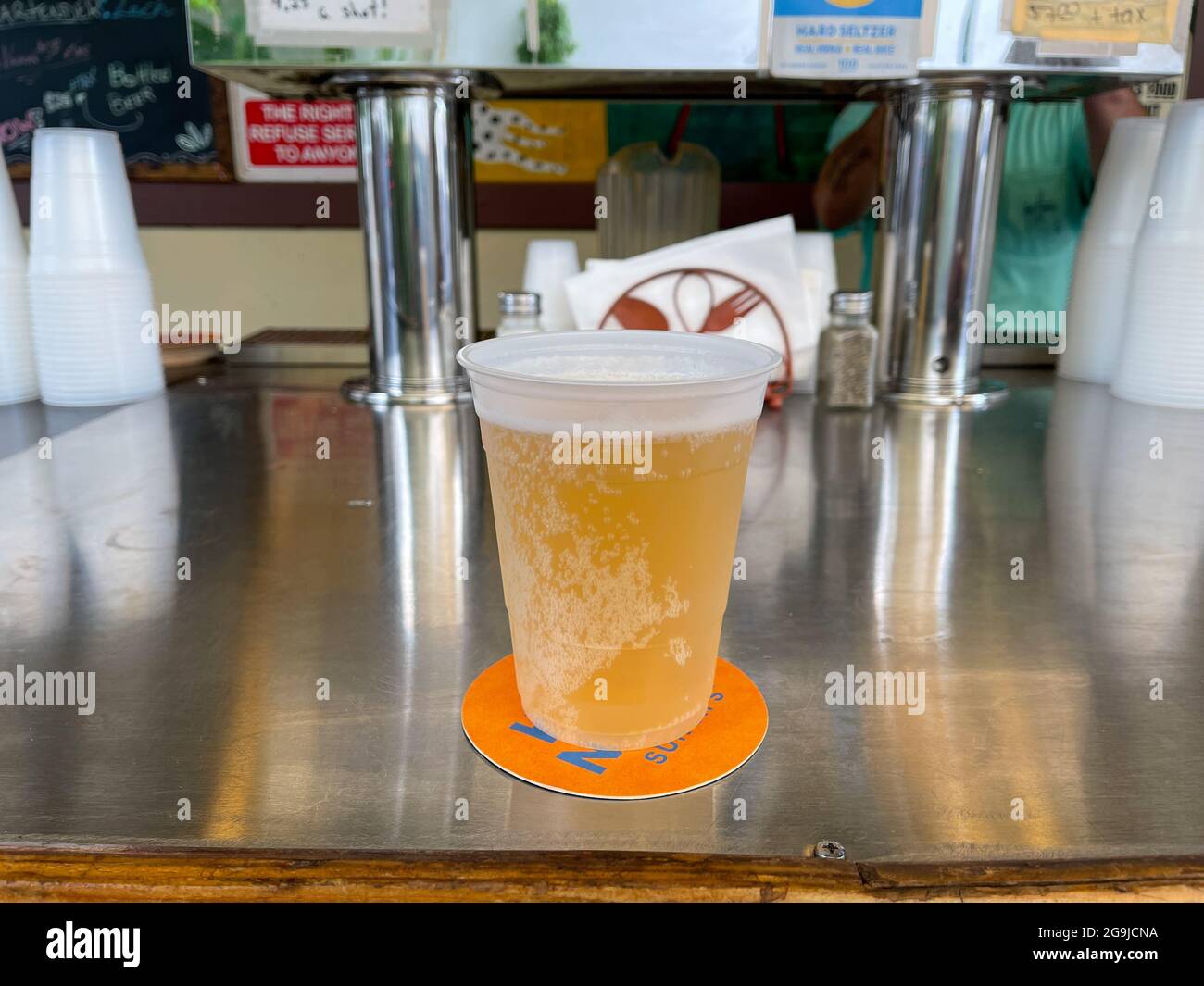 An icy cold draft beer in a glass sitting on a bar in Florida Stock ...
