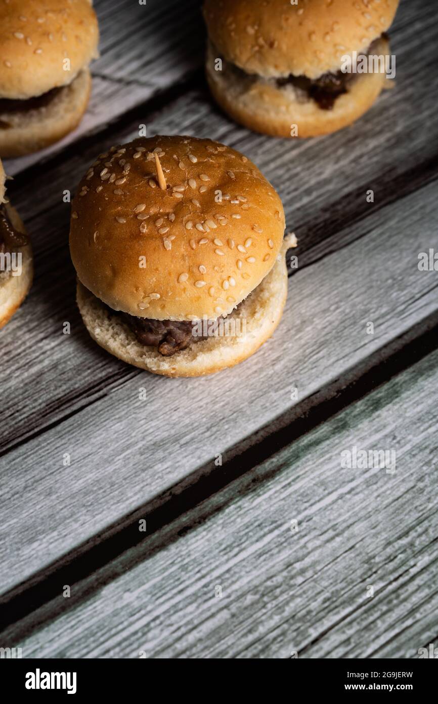 Tiny beef burger close up still with bread slice Stock Photo - Alamy